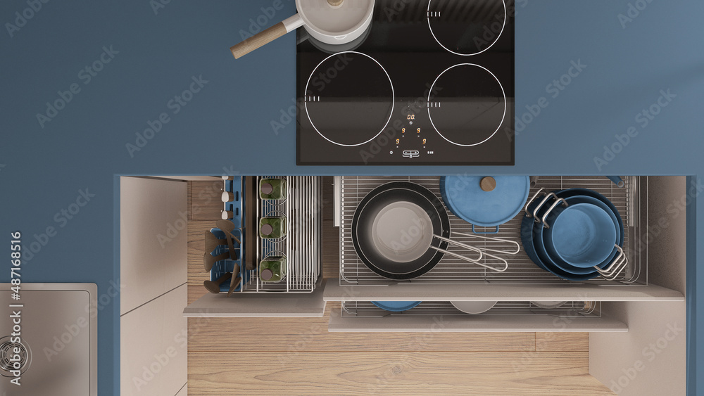 Blue and wooden kitchen close up with open drawers with plates, pots ...