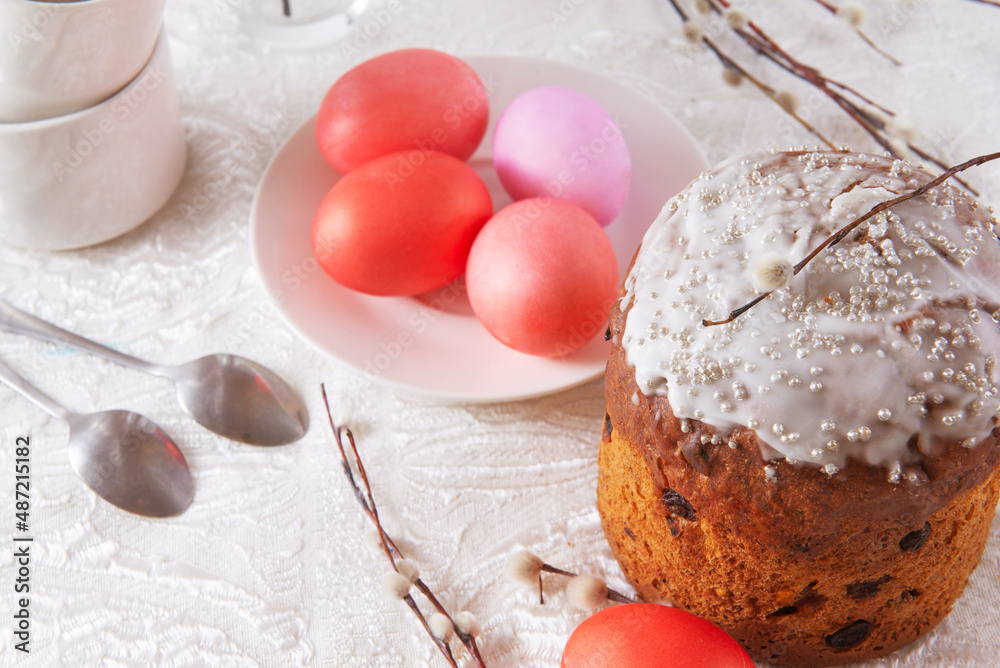 Easter cake with red eggs and willow branches side look white cups ...