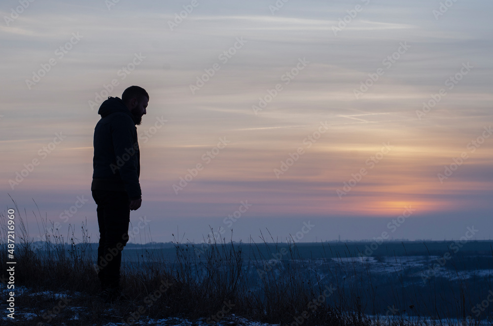 Pray. Repentance. Silhouetted men on a background of blue sky and ...