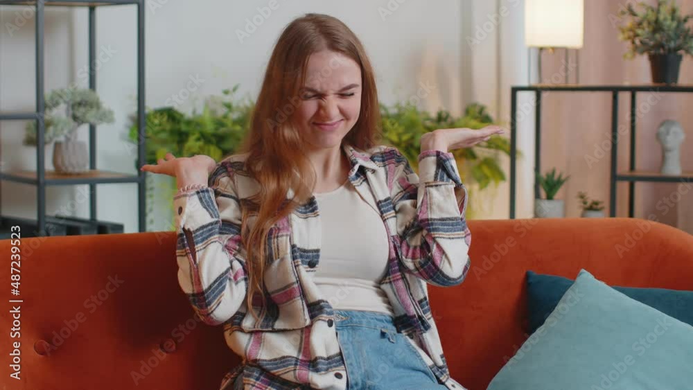 Funny amusing young funny woman in shirt looking awkward making playful ...