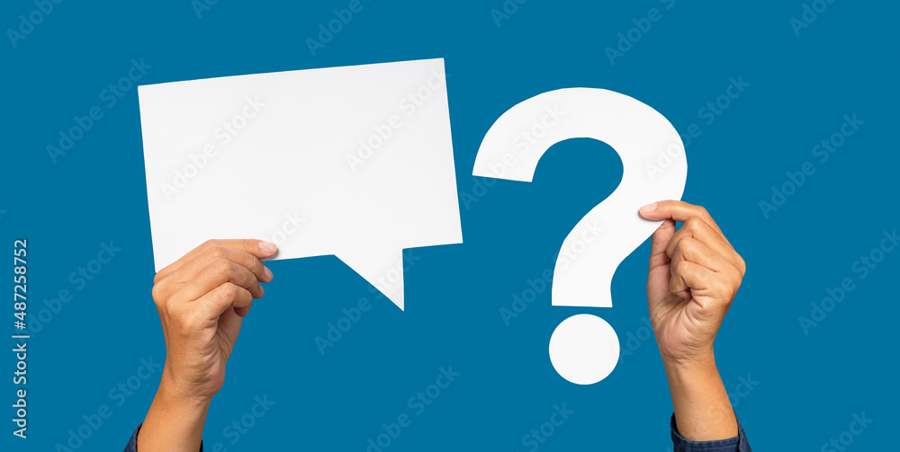 Hand holding a blank white speech bubble and a white question mark on a ...