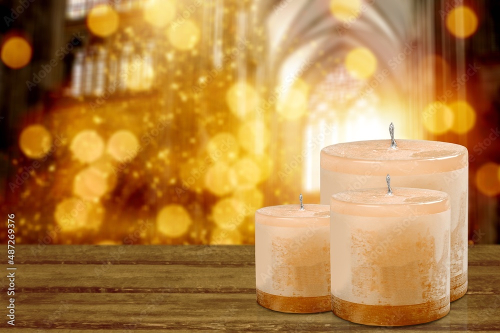 Candles burning light in a church background Stock Photo | Adobe Stock