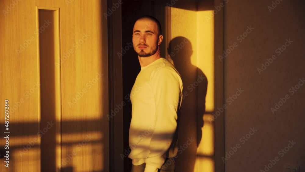 A Man Goes Into The Room, Turns And Sun Rays Shine In His Face. Film ...