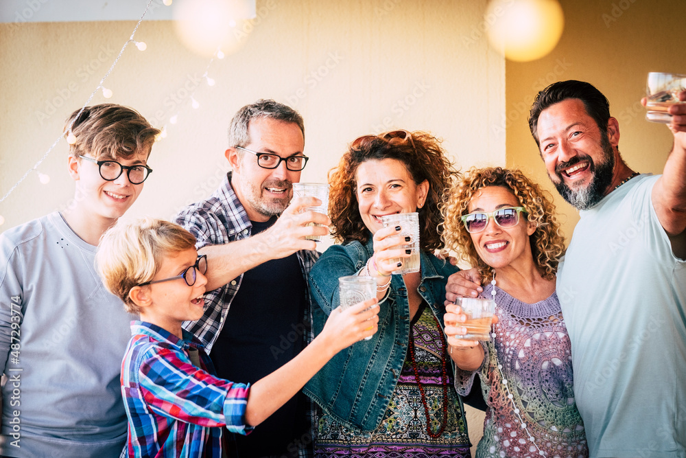 Happy group of friends mixed ages and generations celebrate togeher ...