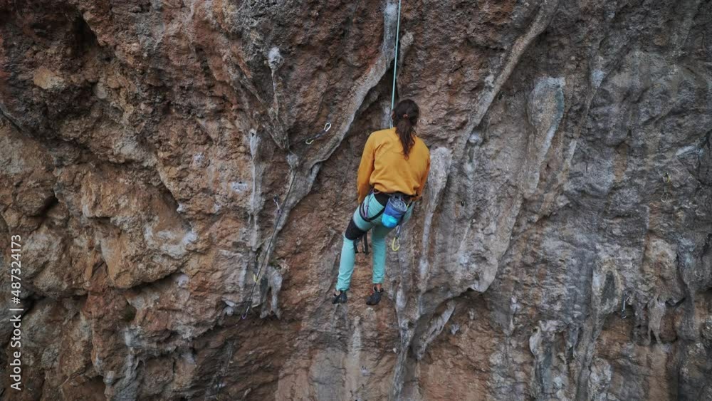 man Rock climber descends from the challenging route on overhanging ...