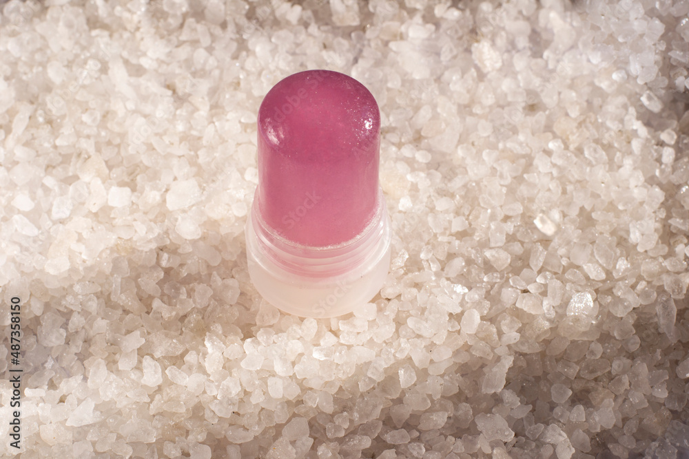 Crystal deodorant from alunite against the background of salt. Pink ...