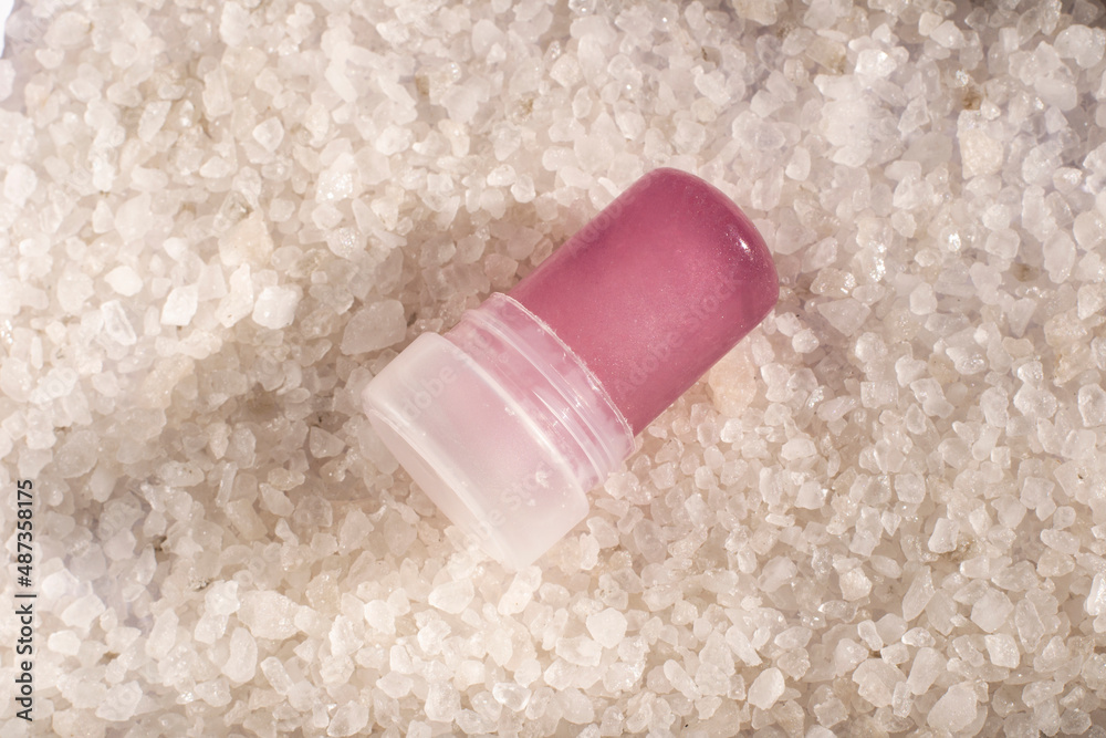 Crystal deodorant from alunite against the background of salt. Pink ...