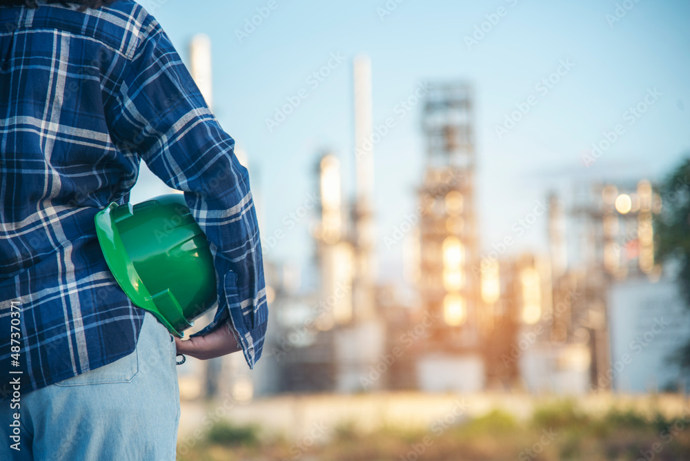 Eco sustainable worker hand holding hardhat green work helmet ...