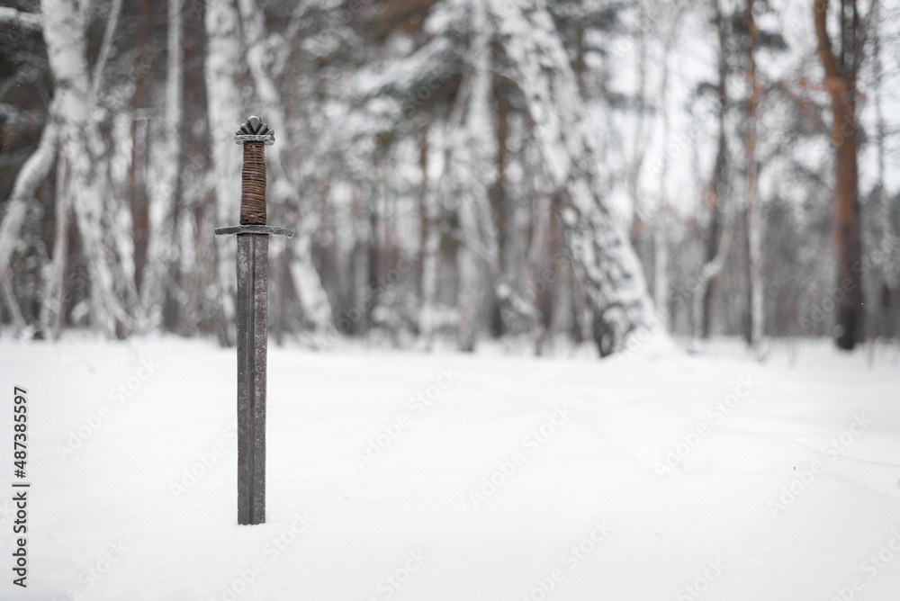 Knight sword in the snow background. The battlefield. Stock Photo ...