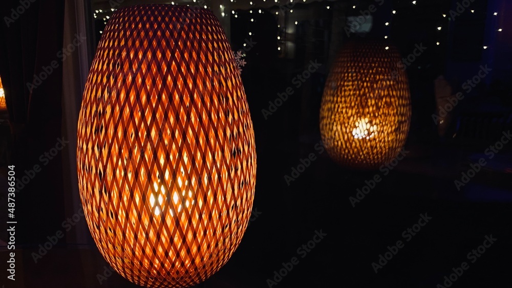 Lampshade and reflection on glass in modern living room at night ...