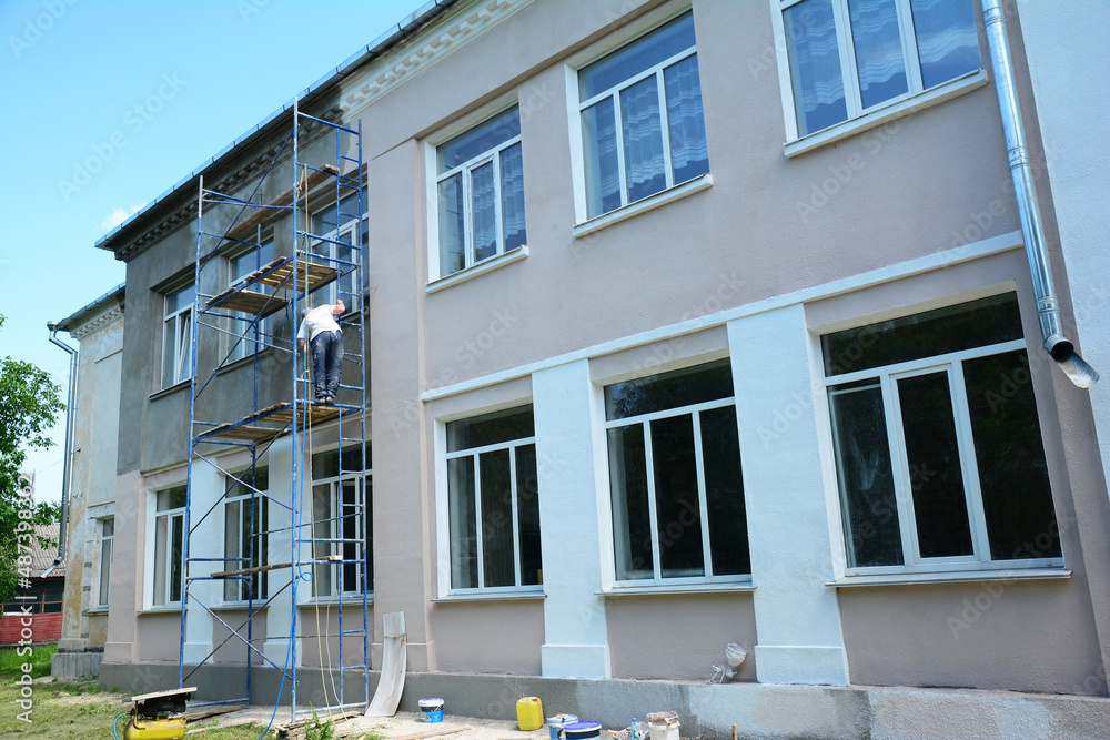 Rendering, renovating, plastering, and painting a stucco facade. The ...