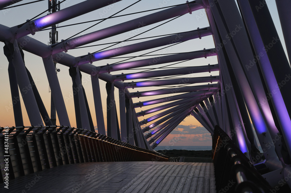 Curved bridge of original architecture for pedestrians and cyclists in ...