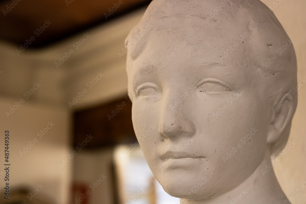 Classic bust of a sculpture made with plaster with some lights at the ...