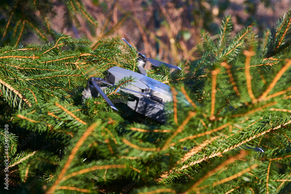 Drone quadcopter accident scene. UAV Quadrocopter crashed on tree in ...