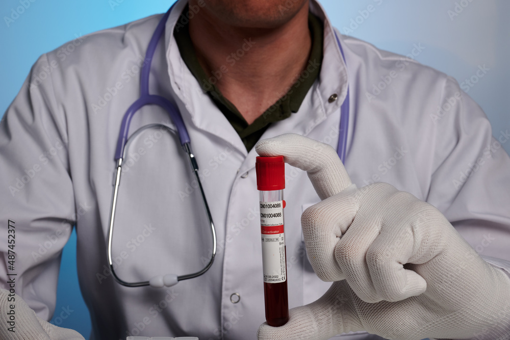 Doctor demonstrates blood analysis test-tube. Vacutainer with blood ...