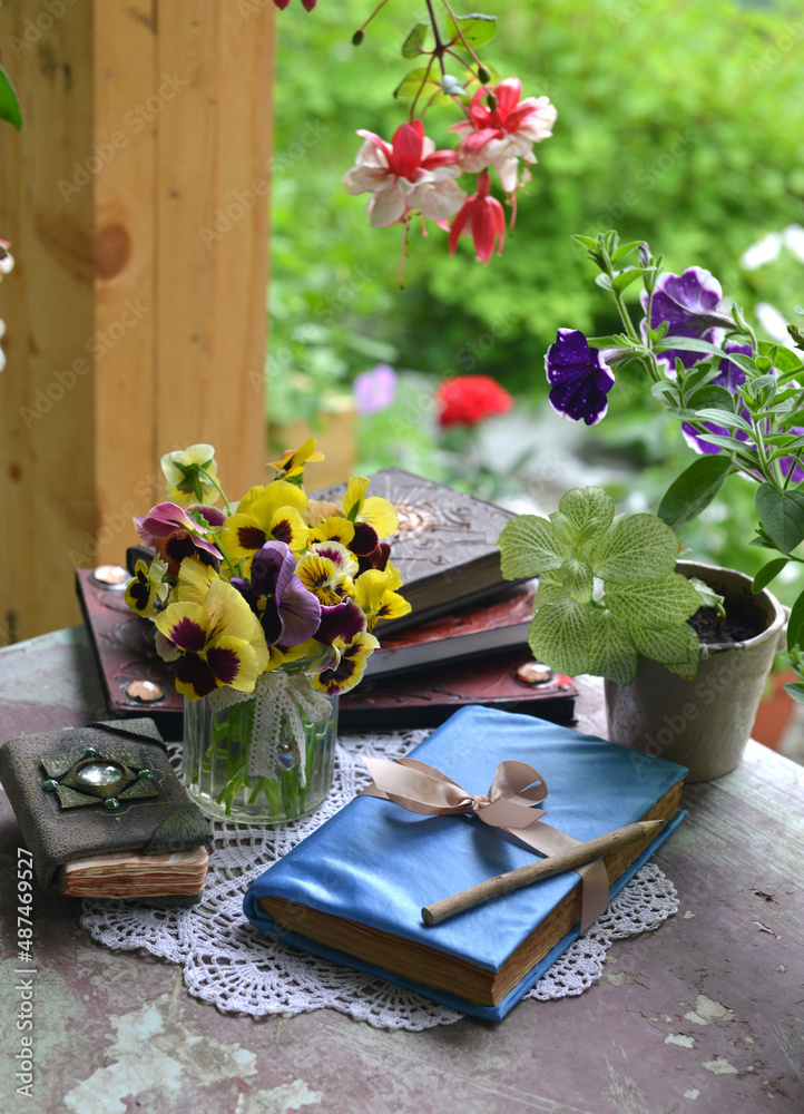 Summer still life with old decorated book, crystal stines and beautiful ...