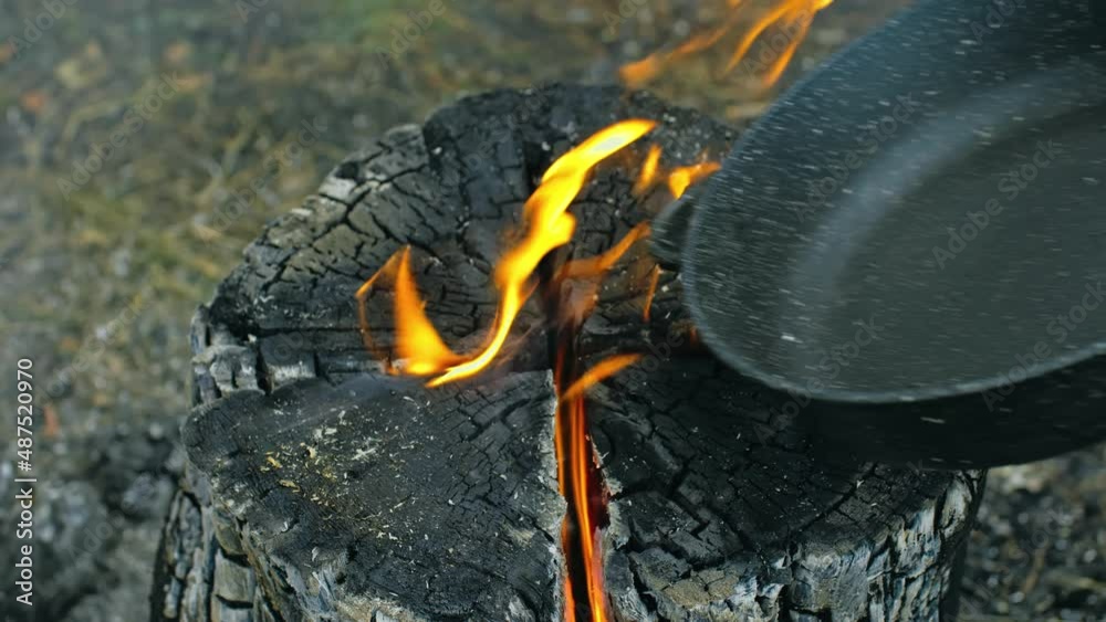 Swedish or finnish log candle. Fire burning from inside the wooden log ...