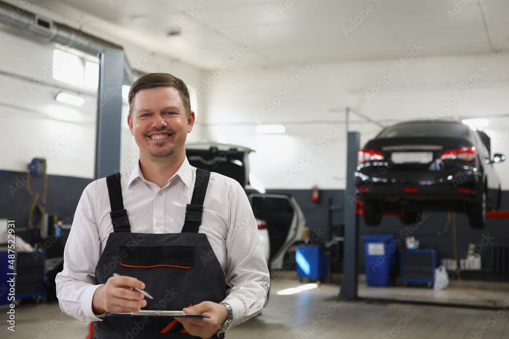 Smiling qualified maintenance center worker in uniform, man posing on ...