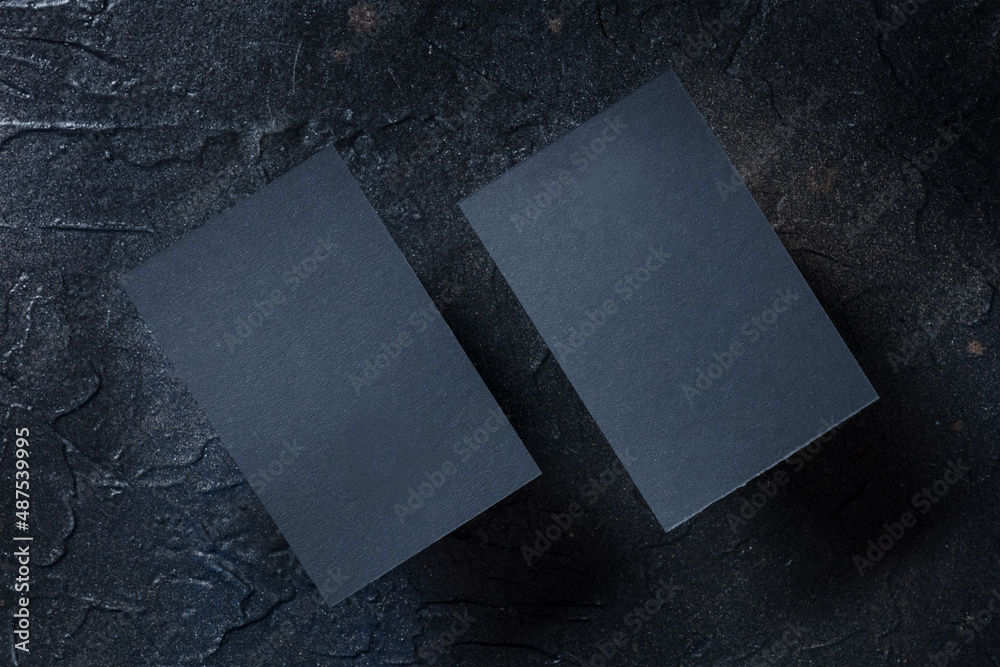 Black business card mock-up on a dark background, front and back, a ...
