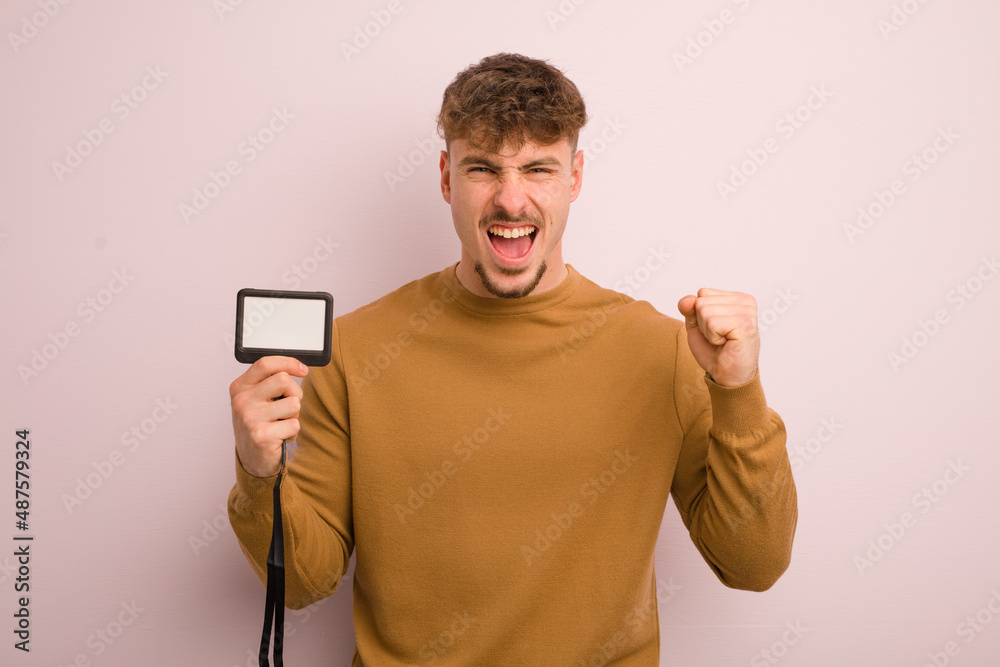 young cool man shouting aggressively with an angry expression. vip pass ...