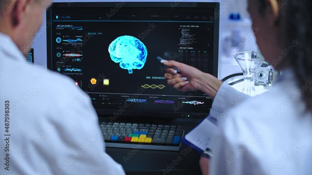 Team of clinical scientists studying 3D brain image, neurology ...