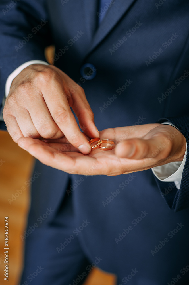 Gold rings in mens hands 4034. Stock Photo | Adobe Stock