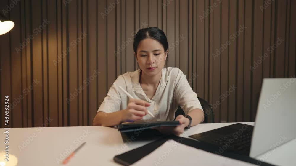 Serious young woman learning practicing on an online drawing and ...
