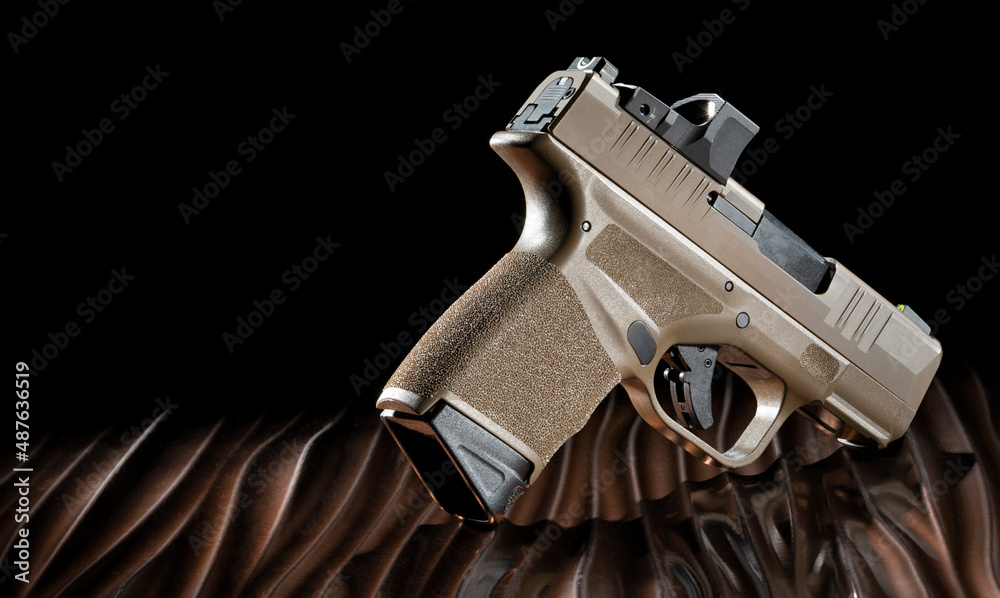 Tan semi auto pistol with a red dot optic Stock Photo | Adobe Stock