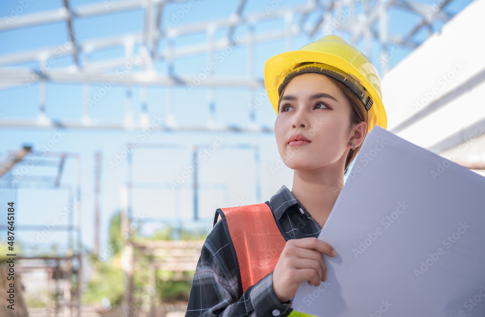 Asian woman civil engineer wear yellow safety hard hat standing and ...