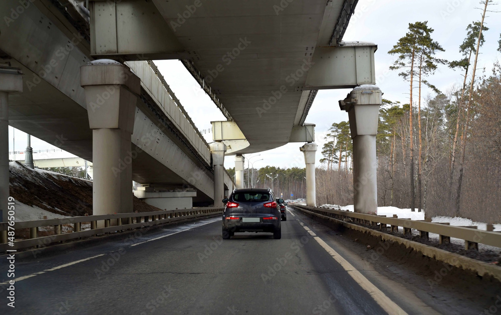 Stockfoto Cars are moving in a traffic jam under a trestle bridge in a ...