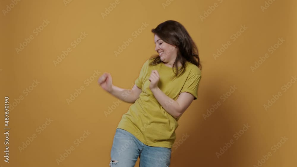 Portrait of smiling happy young person dancing alone in studio feeling ...
