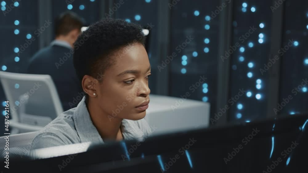 Beautiful african woman using computer desktop developing software ...