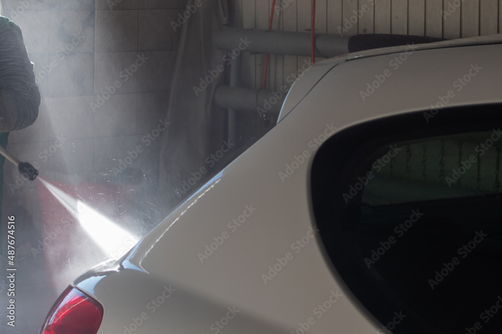 Washing white car with powerful water jet in open garage Stock Photo ...
