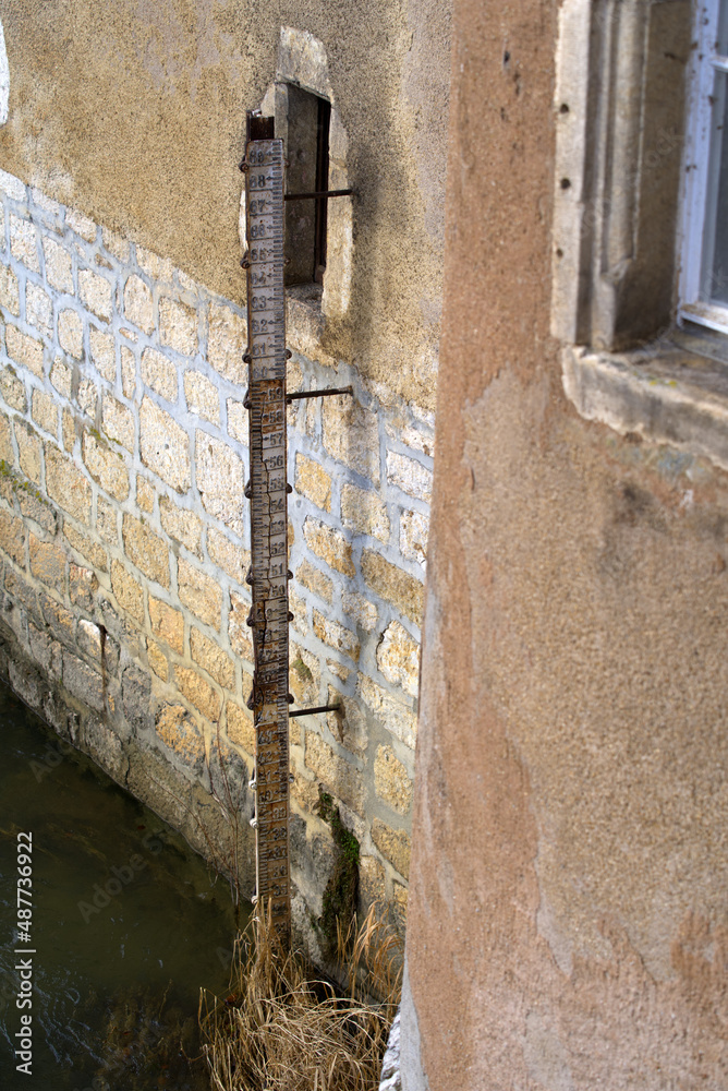 Water level indicator at wall of historic house at medieval town of St ...