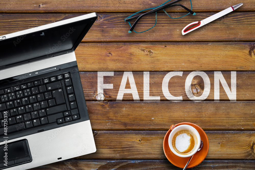 Falcon Programming Language. Word Falcon on wooden desk and laptop ...