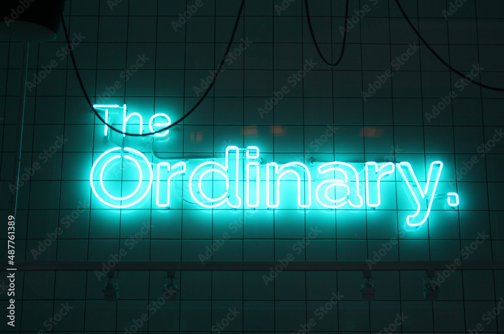 A low-angle shot of a Neon sign saying "The Ordinary" Stock Photo ...