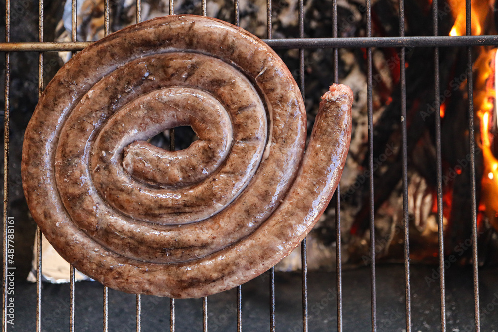 Boerewors sausage on a braai grid Stock Photo | Adobe Stock