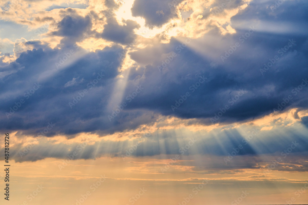 Sun rays and clouds, sunbeams shining through cumulus clouds, stunning ...