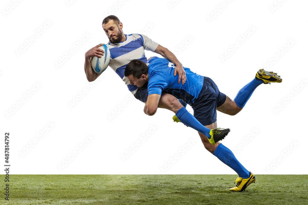 Dynamic portrait of male rugby players playing rugby football on grass ...