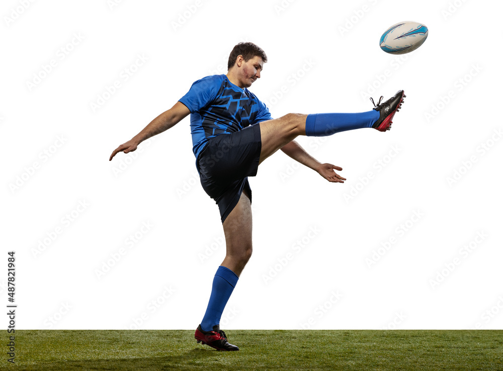 Professional rugby player wearinf blue sports uniform kicks ball ...