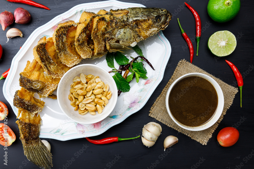 Snake head fish fried serve with Boiled Fermented Fish sauce or Pickled ...
