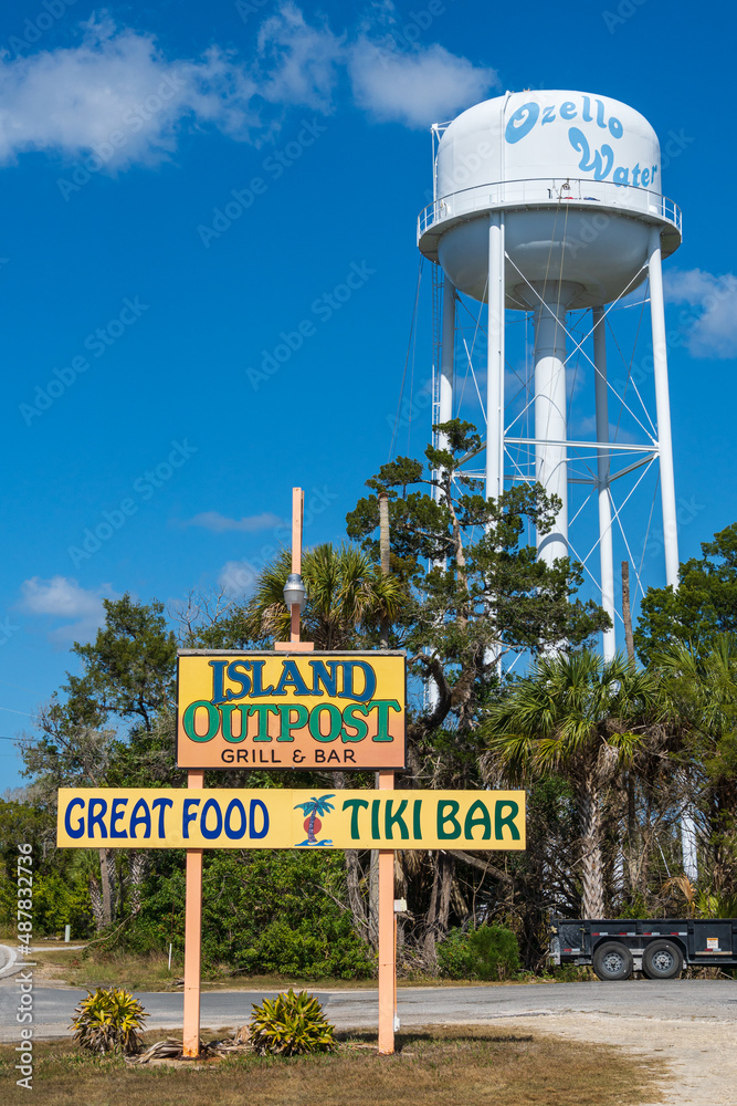 Island Outpost Grill and Bar sign and Ozello water tower, vertical shot ...