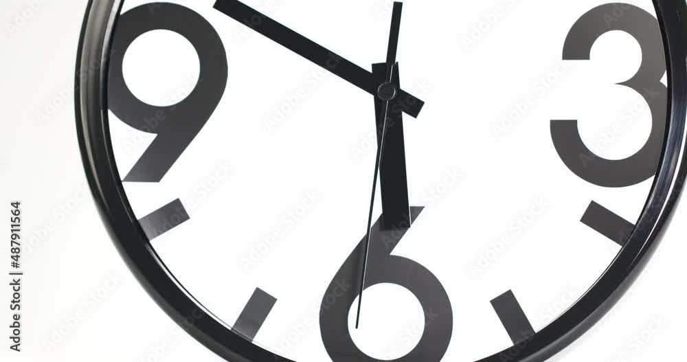 Close-up black second hand rotates clockwise on the watch face. Slowly ...