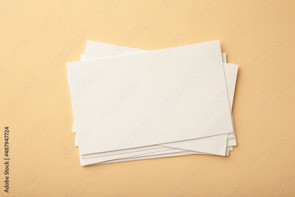 Blank white business cards on beige paper background. Mockup for ...