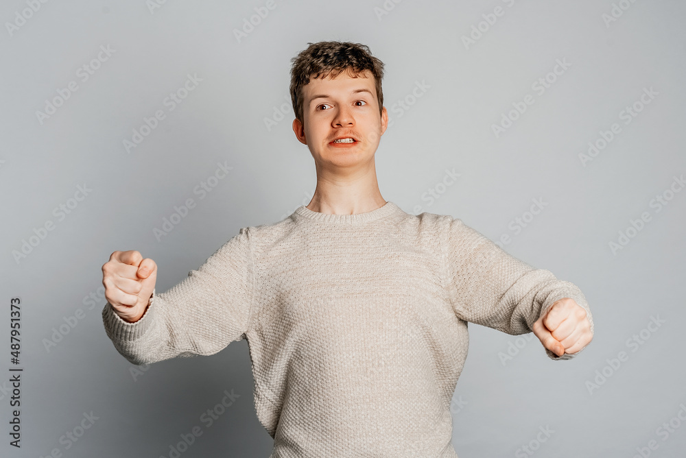 Aggressive outraged teen boy gestures angrily screams loudly expresses ...
