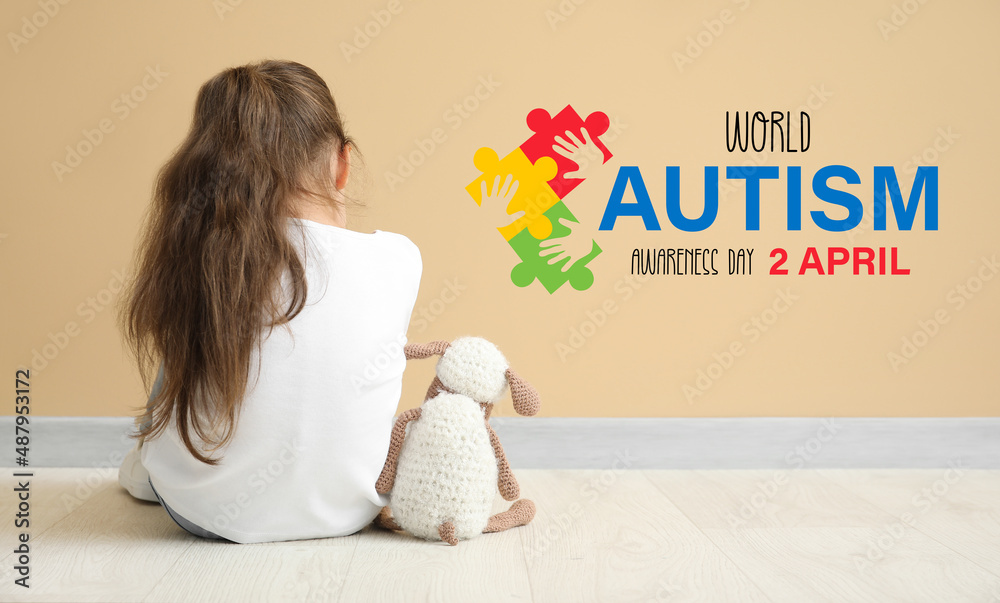 Sad little girl with autistic disorder near color wall, back view ...