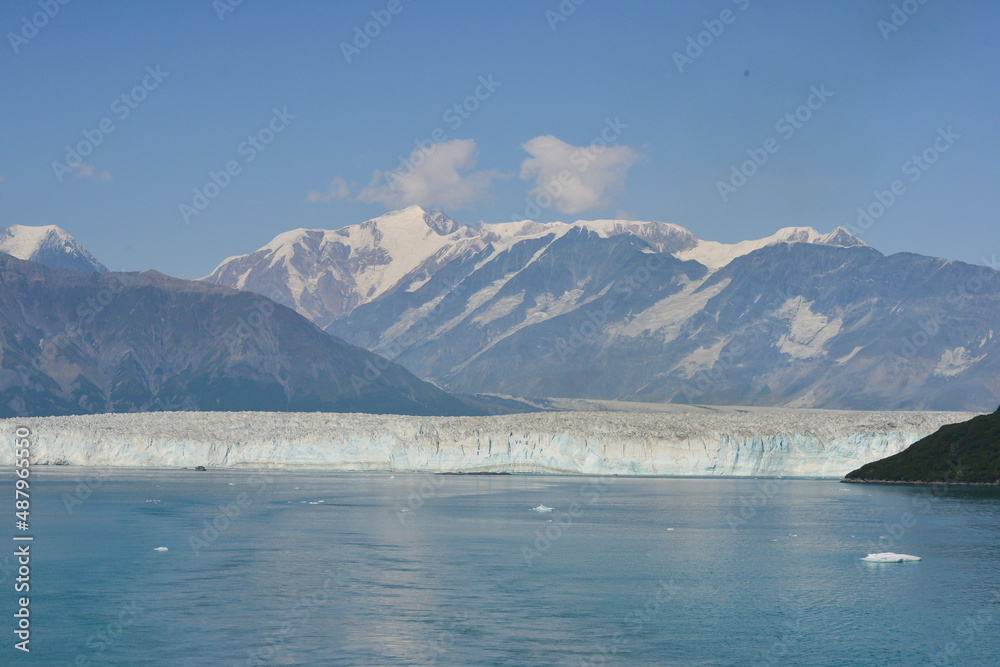 Alaska ice Floe into ocean with snow covered mountains as a backdrop ...