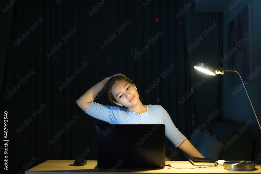 Asian woman are stretch lazily while working long hours in front of a ...