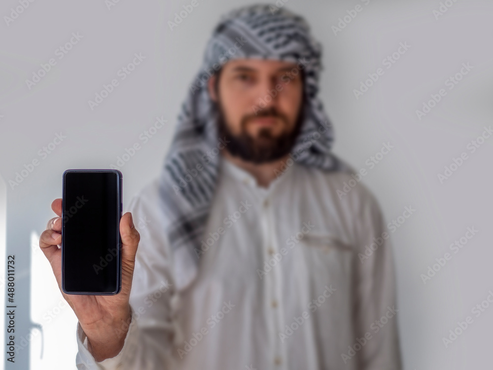 Mockup for mobile app or website. Arab man holding smartphone with ...