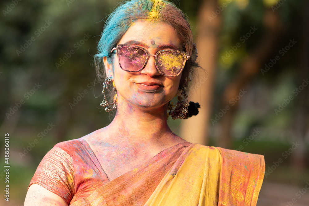 Holi festival of color, a beautiful young girl woman lady in indian ...